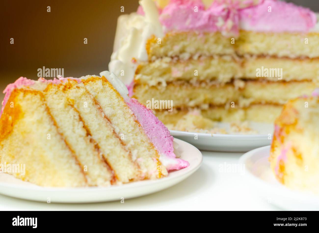 Moist madeira sponge, layered with plum and raspberry jam, coated and ...