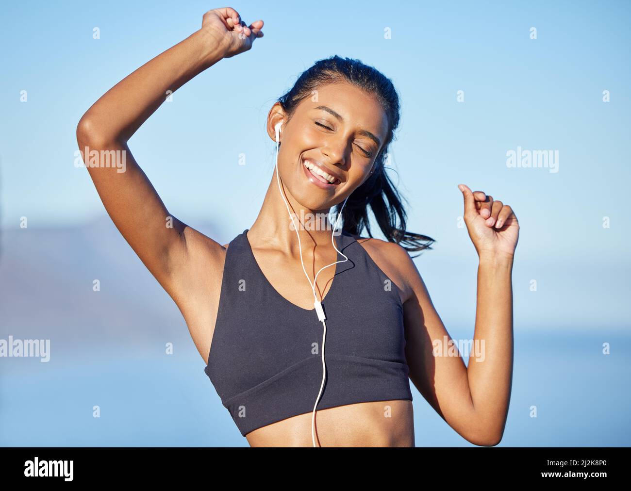 Music lifts my mood in an instant. Shot of a sporty young woman ...