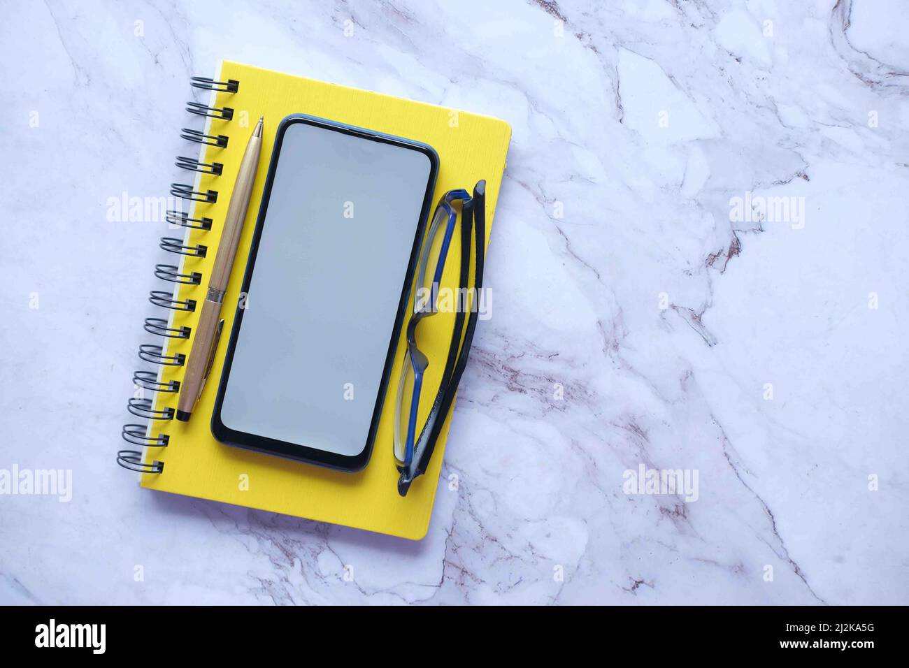 top view of smart phone and notepad on tiles background Stock Photo - Alamy