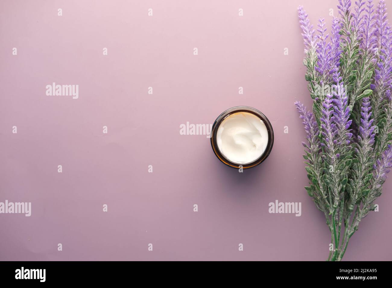 herbal cream cosmetic in a container on purple background Stock Photo ...