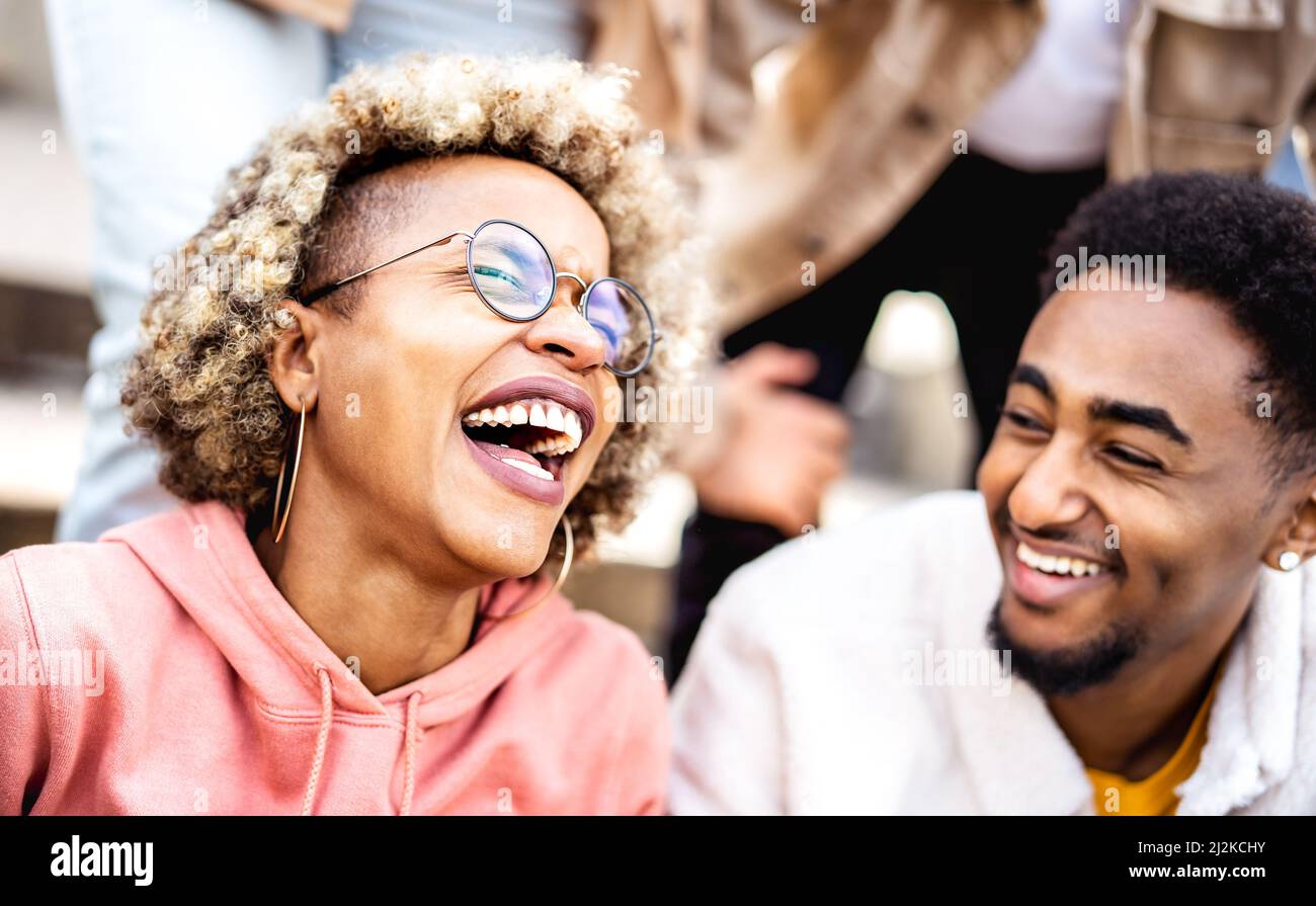 Multicultural couple on genuine laughter - Life style concept with happy multiracial friends ...