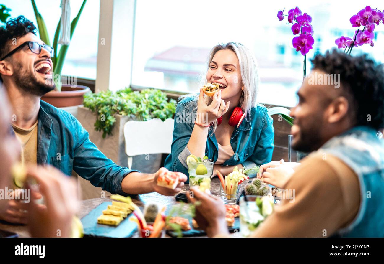 Multicultural friends eating together at luxury pub restaurant - Life ...