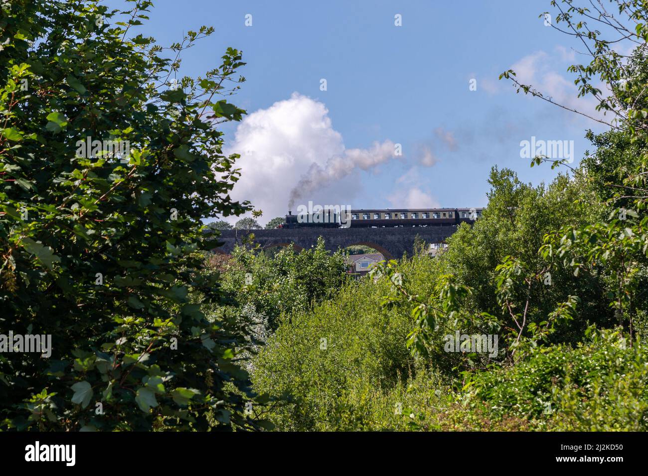 Retro steam train on stone arched railway viaduct Stock Photo - Alamy