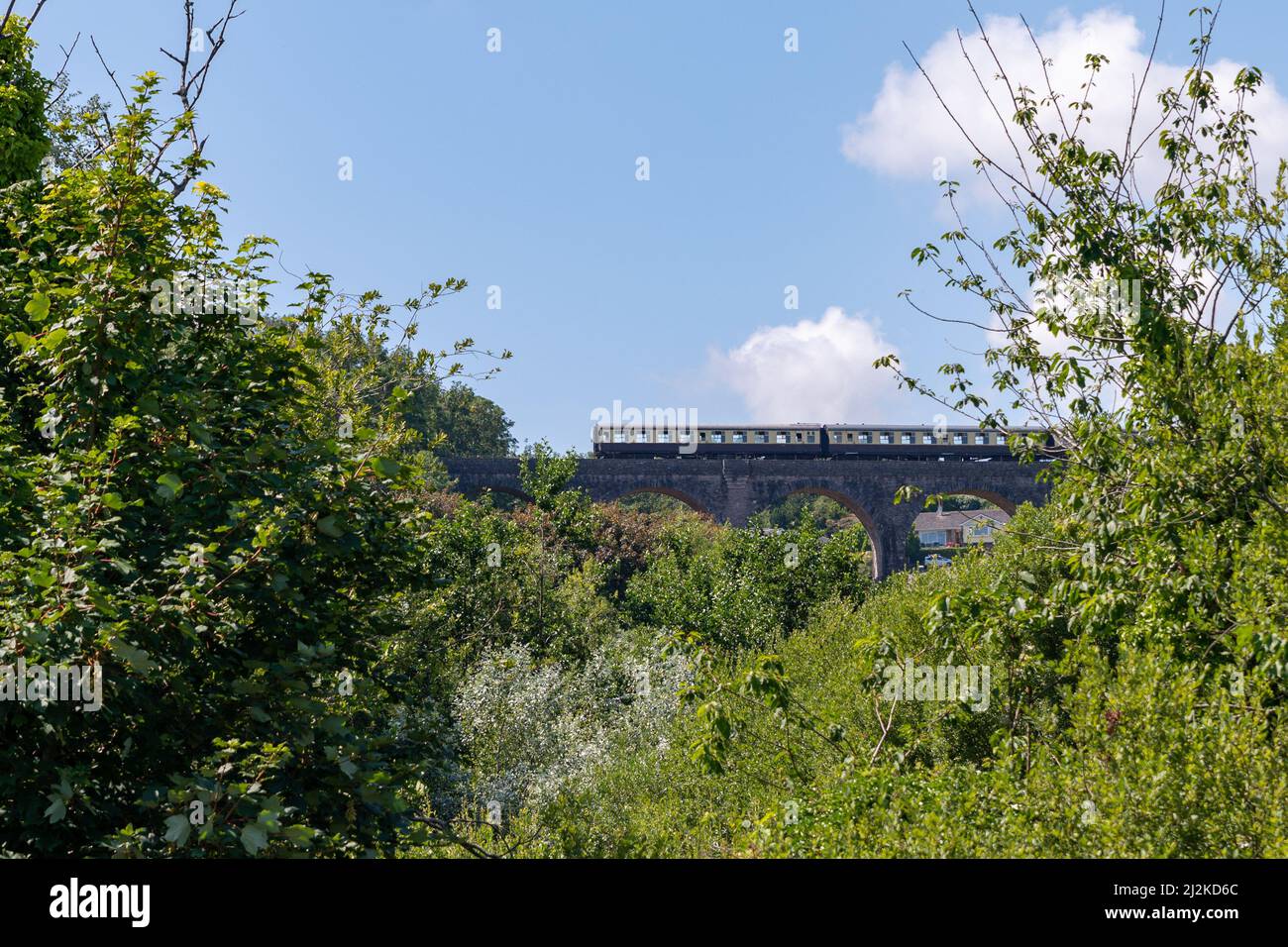 Retro steam train on stone arched railway viaduct Stock Photo - Alamy