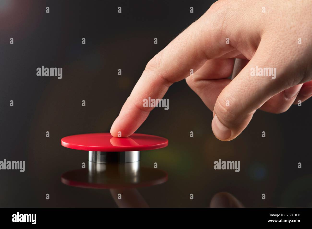 The hand presses the big red button. The concept of the threat of ...