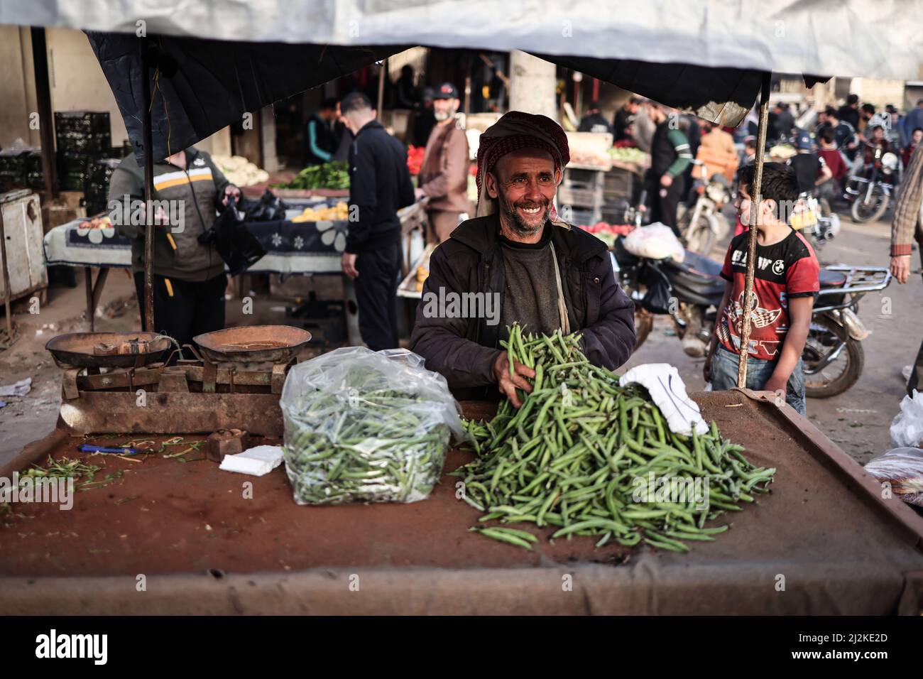 Idlib, Syria. 02nd Apr, 2022. A Syrian vendor sells vegetables at a ...