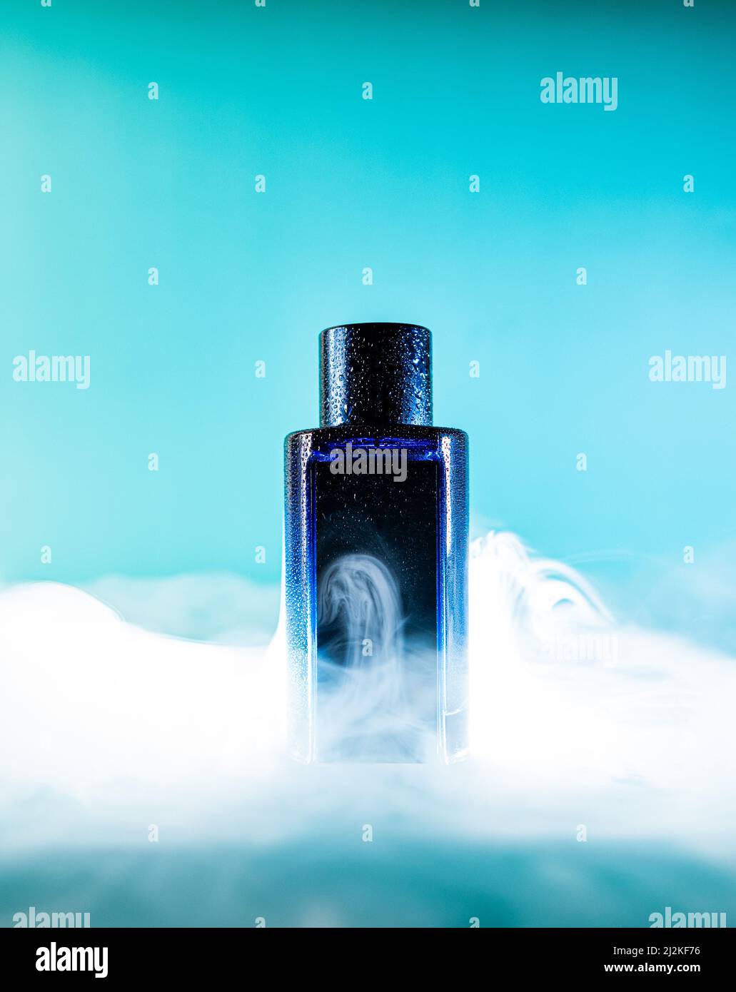 blue bottle of perfume water on a blue background with smoke elements ...