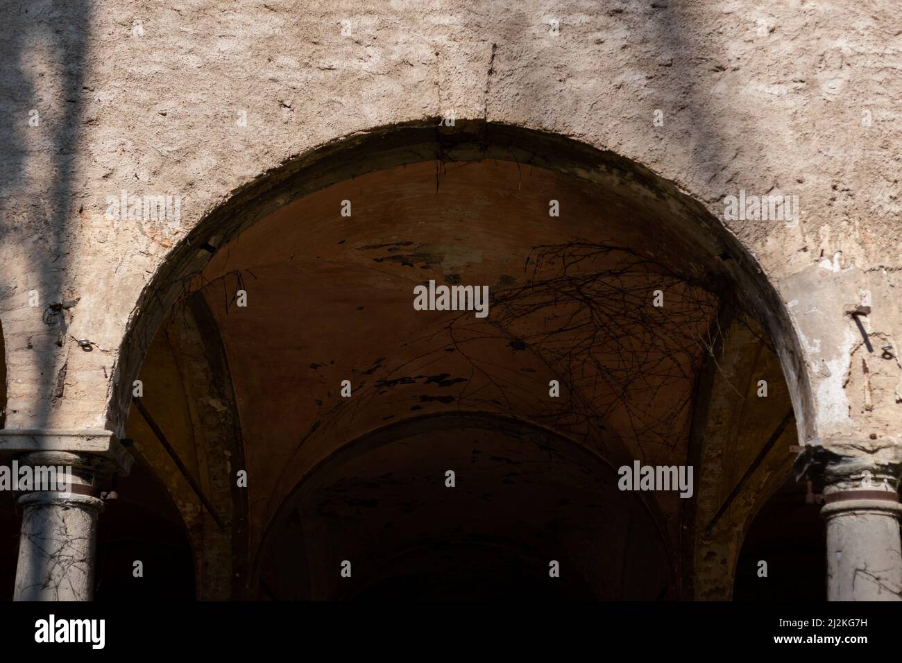 an arch with columns in an ancient building in italy beautiful ...
