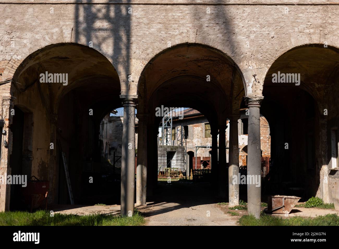 an arch with columns in an ancient building in italy beautiful ...
