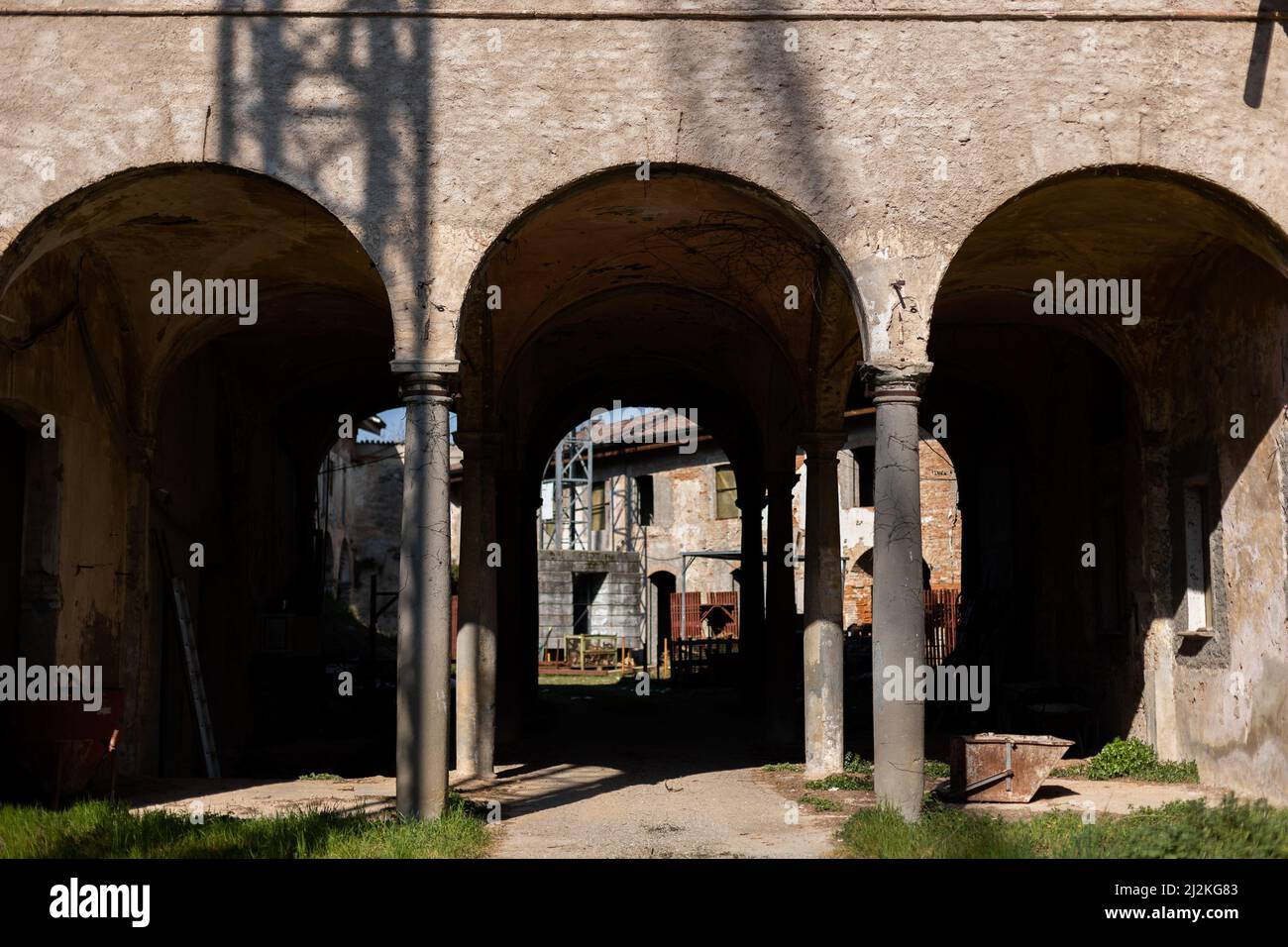 an arch with columns in an ancient building in italy beautiful ...