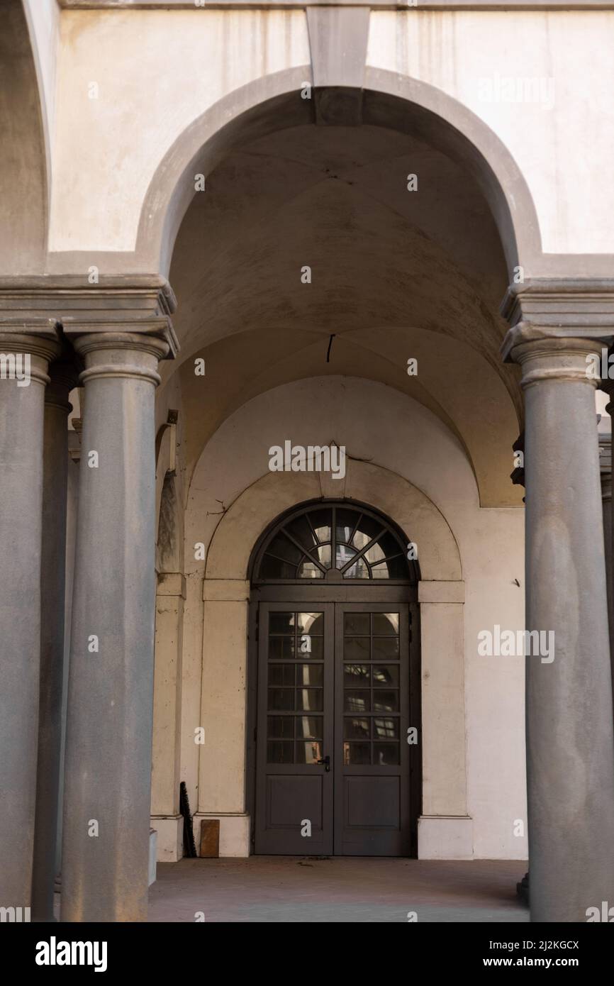 an arch with columns in an ancient building in italy beautiful ...