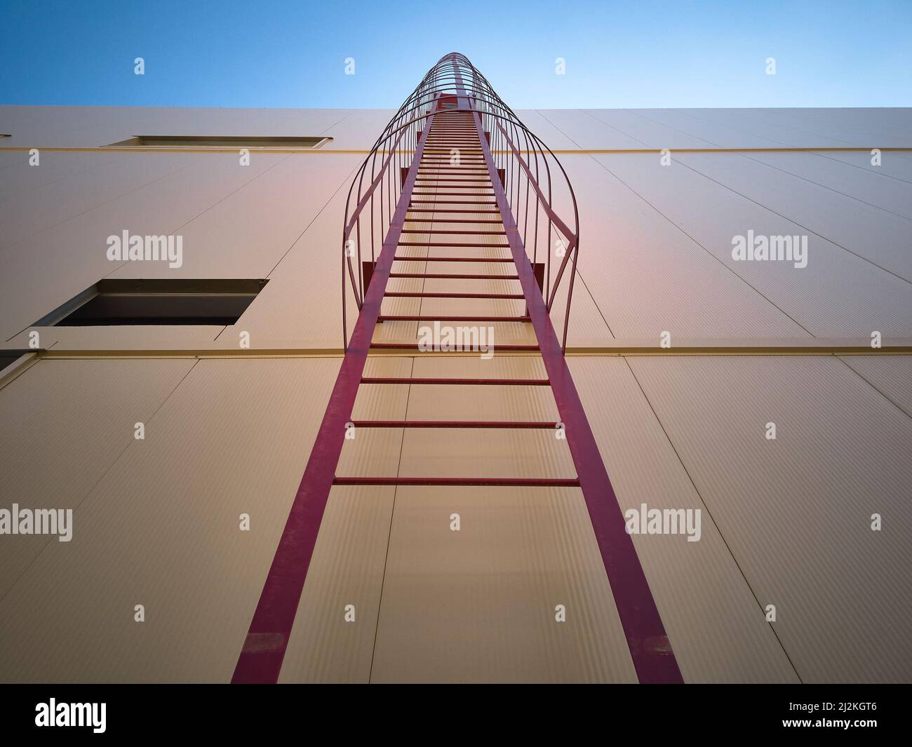 Outdoor fire escape ladder on industrial building wall Stock Photo - Alamy