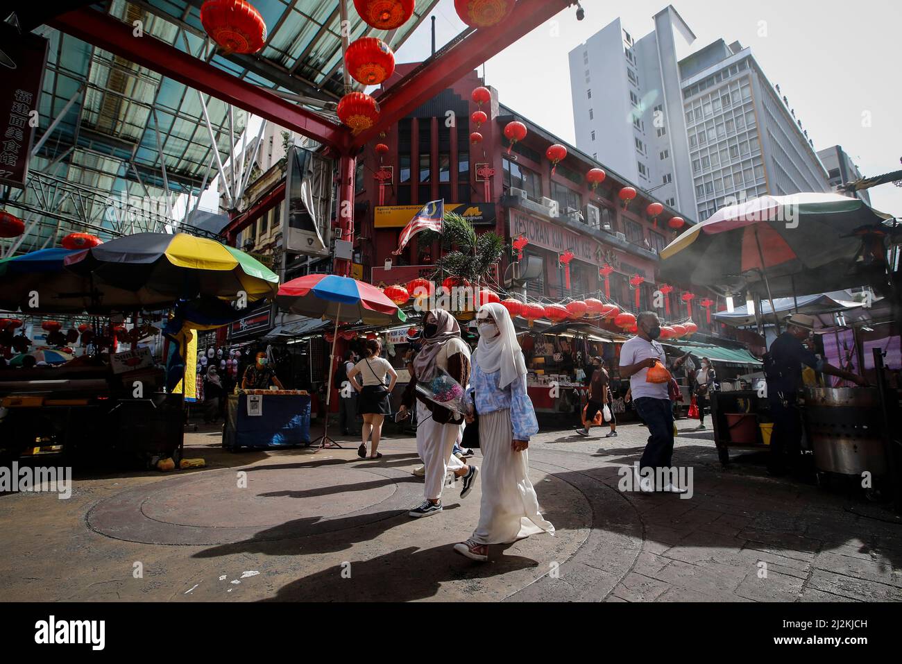 People are seen walking along the China Town district. Malaysia reopens ...