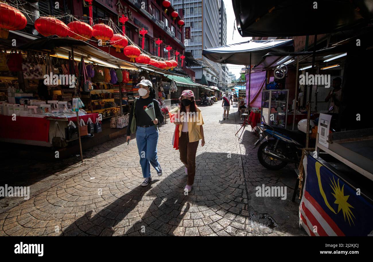 A couple is seen walking along the China Town district. Malaysia ...