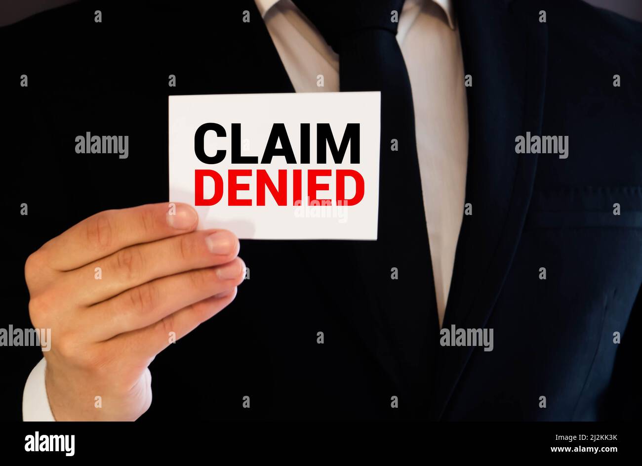 Businessman holding a card with text Claim Denied Stock Photo - Alamy Businessman holding a card with text Claim Denied Stock Photo - Alamy