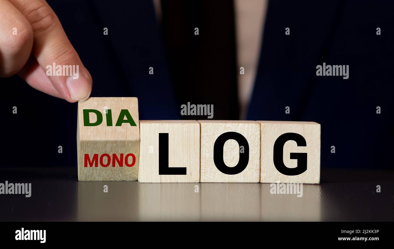 Hand flips a dice and changes the German word monolog dialog Stock ...