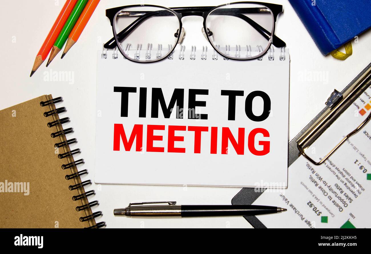 TIME TO MEETING text word inscription written on white notebook on ...