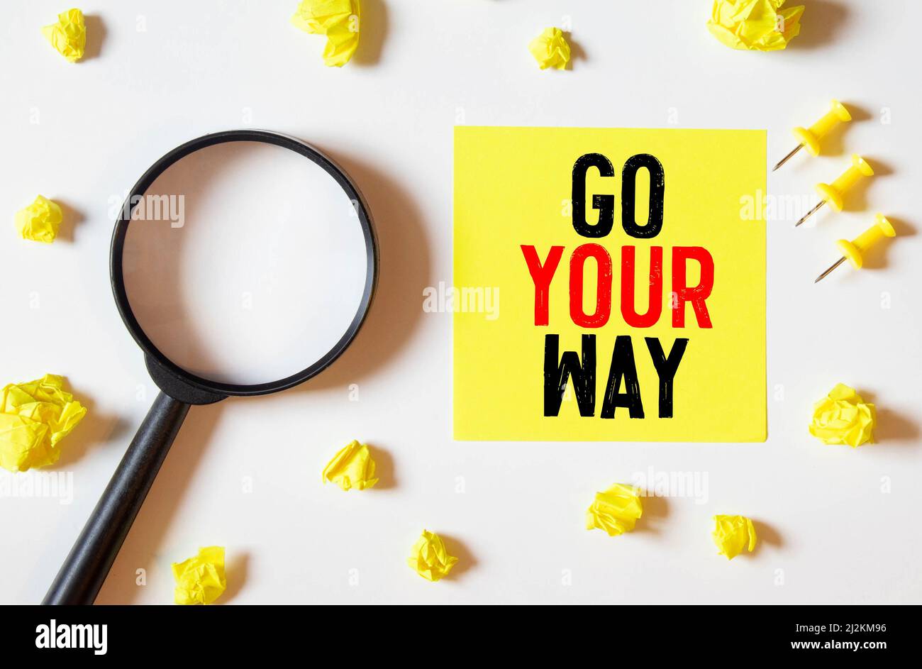 yellow sticker inscription Go your own way attached blue magnet white ...