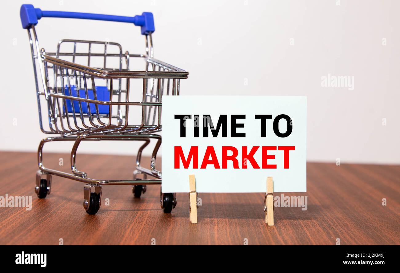 Notepad with text Time To Invest on Market charts and alarm clock Stock ...