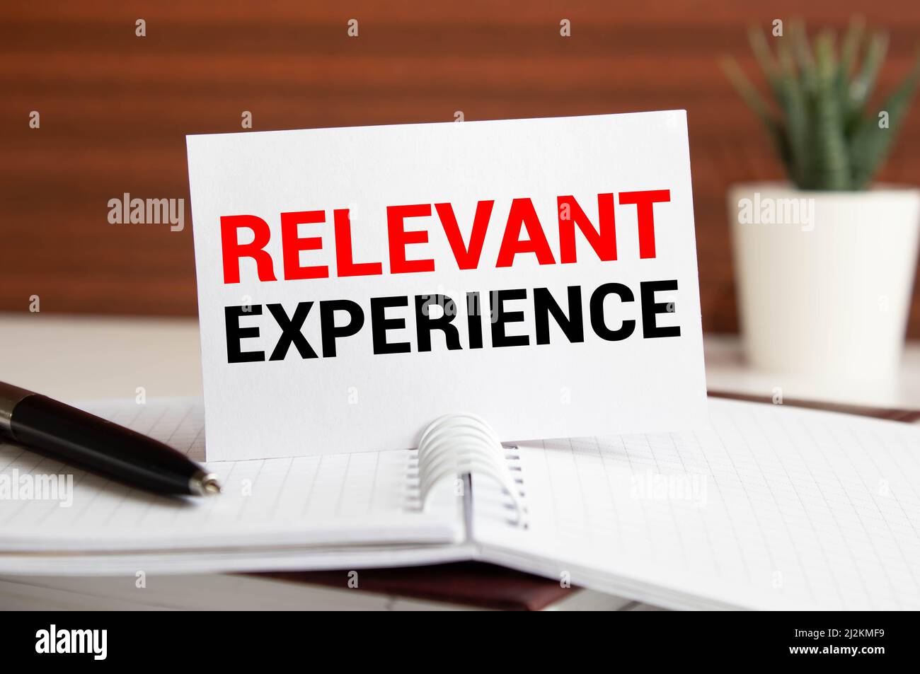Closeup on businessman holding a card with RELEVANT EXPERIENCE message ...