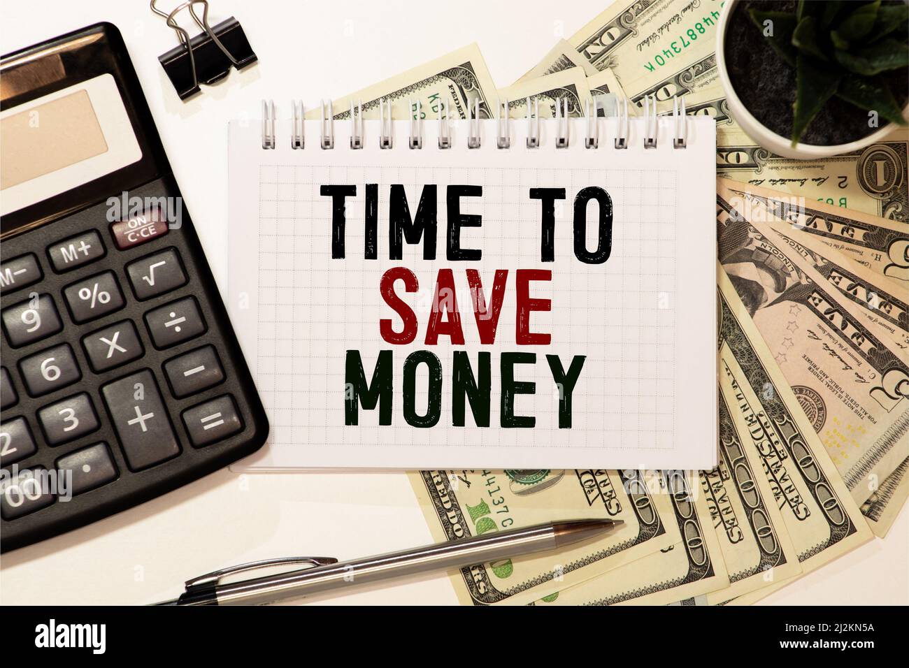 Paper plate with text TIME TO SAVE MONEY. Diagram, calculator, notepad ...