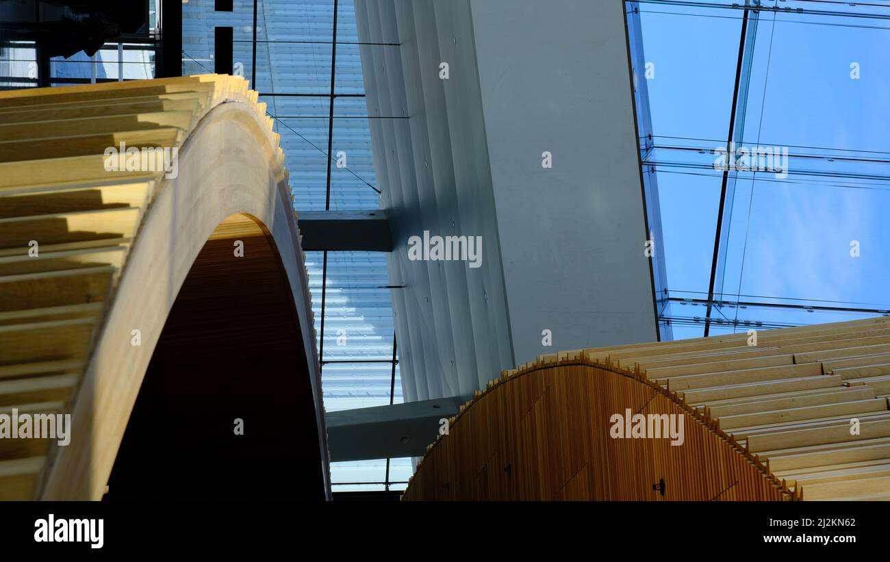 A vertical shot of a modern lobby of Oslo Opera house with tall windows ...