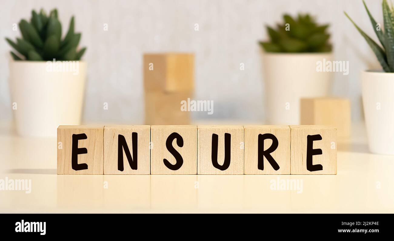 ENSURE word made with building blocks, concept Stock Photo - Alamy