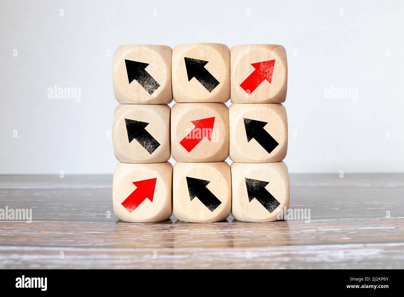 Wood block red arrow pointing the opposite way disruptive from the ...