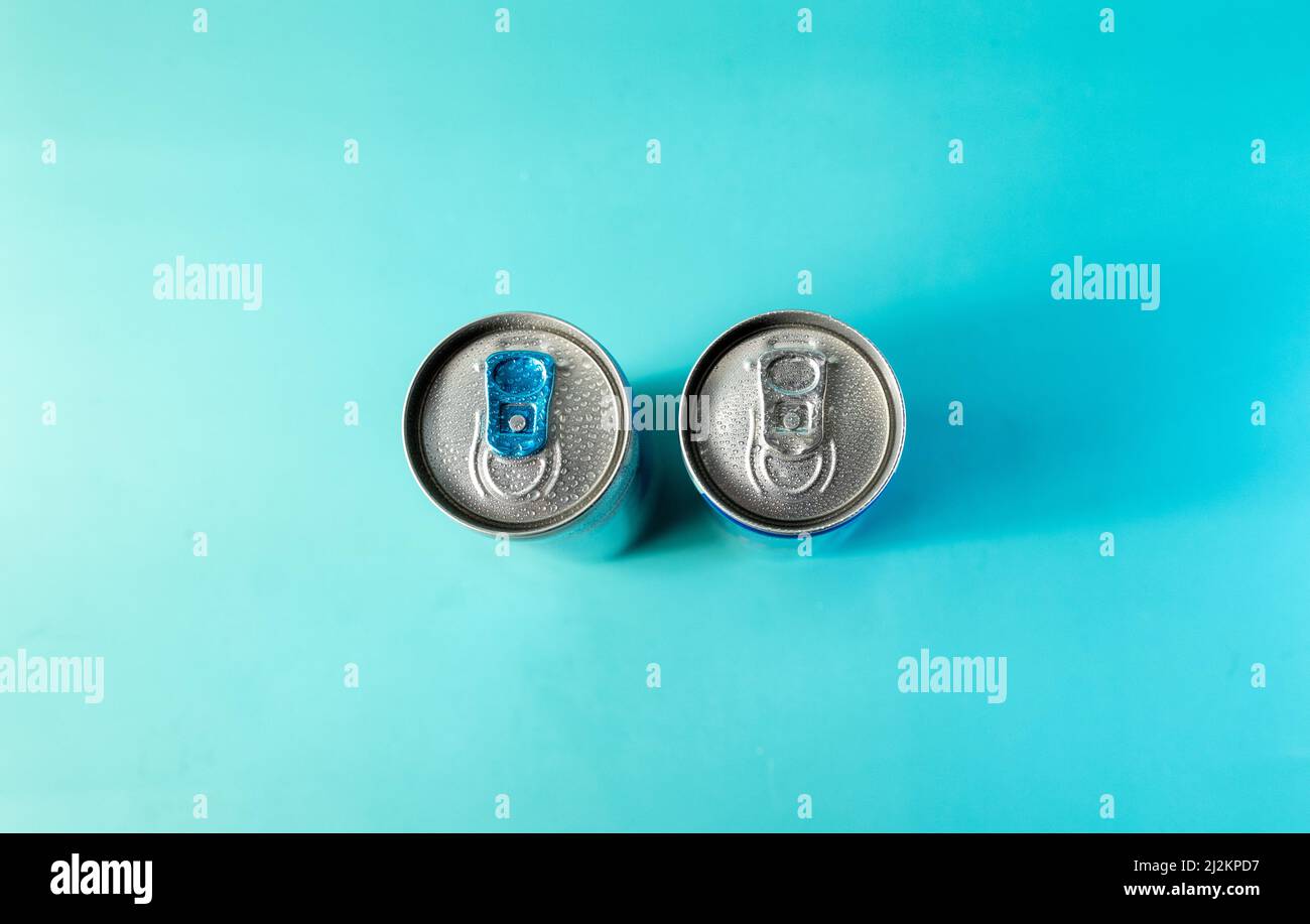 aluminum cans with soda condensate on a blue background Stock Photo - Alamy