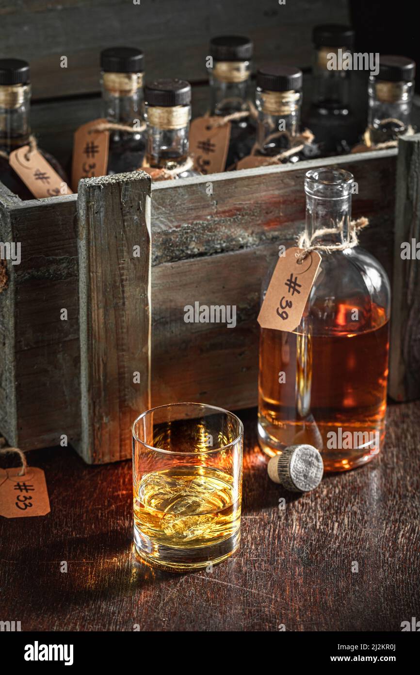 Good and aged cognac and wooden box with bottles in distillery. Glass ...