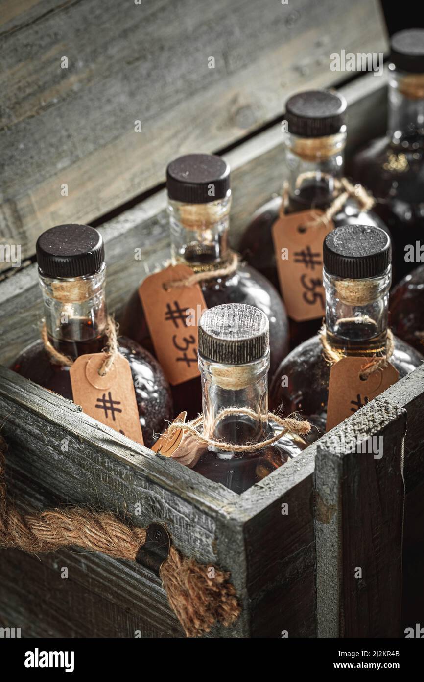 Old and good cognac and wooden box with bottles in distillery. Glass of ...