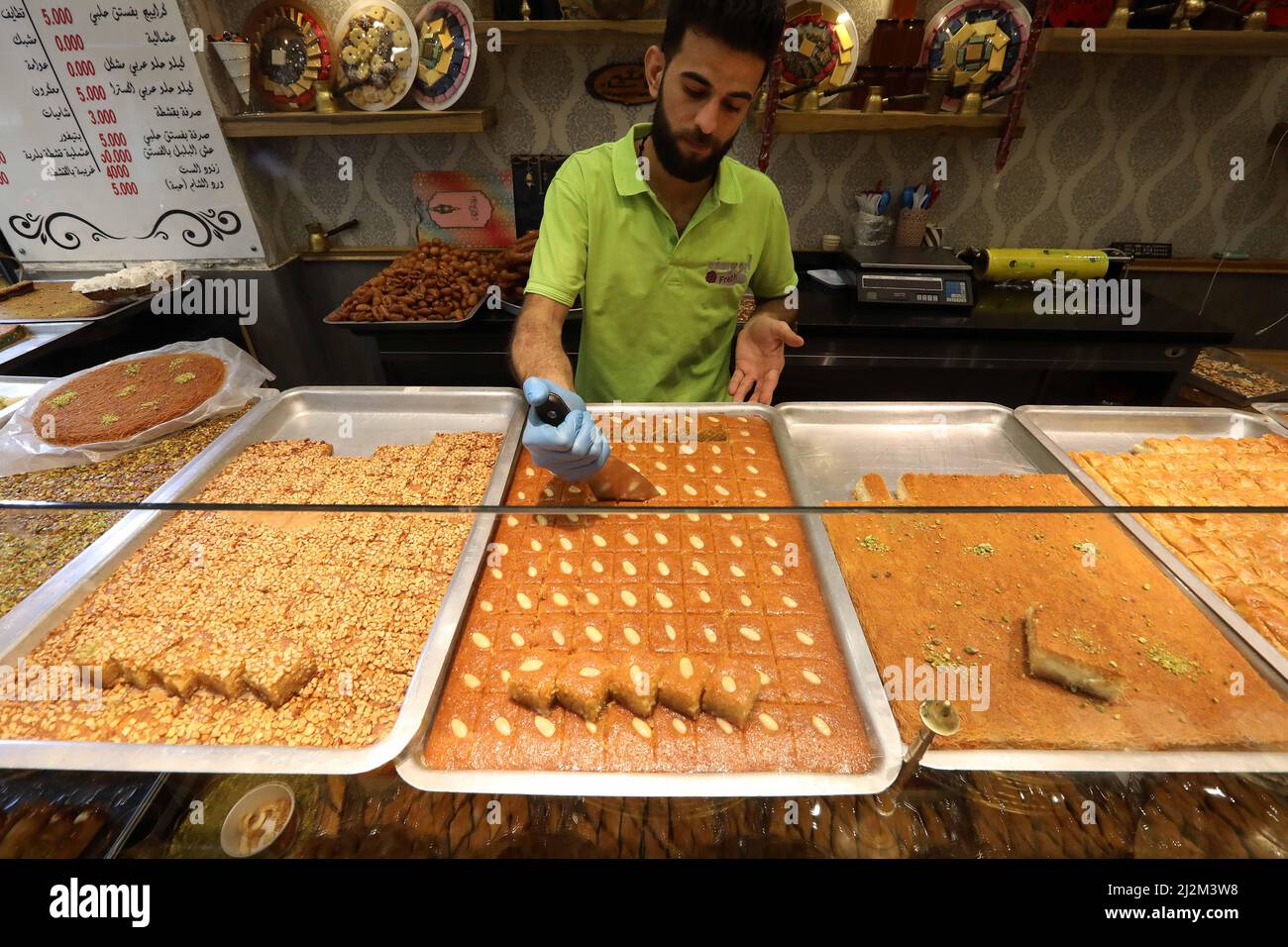 Beirut, Lebanon. 2nd Apr, 2022. A man prepares sweets in Beirut ...