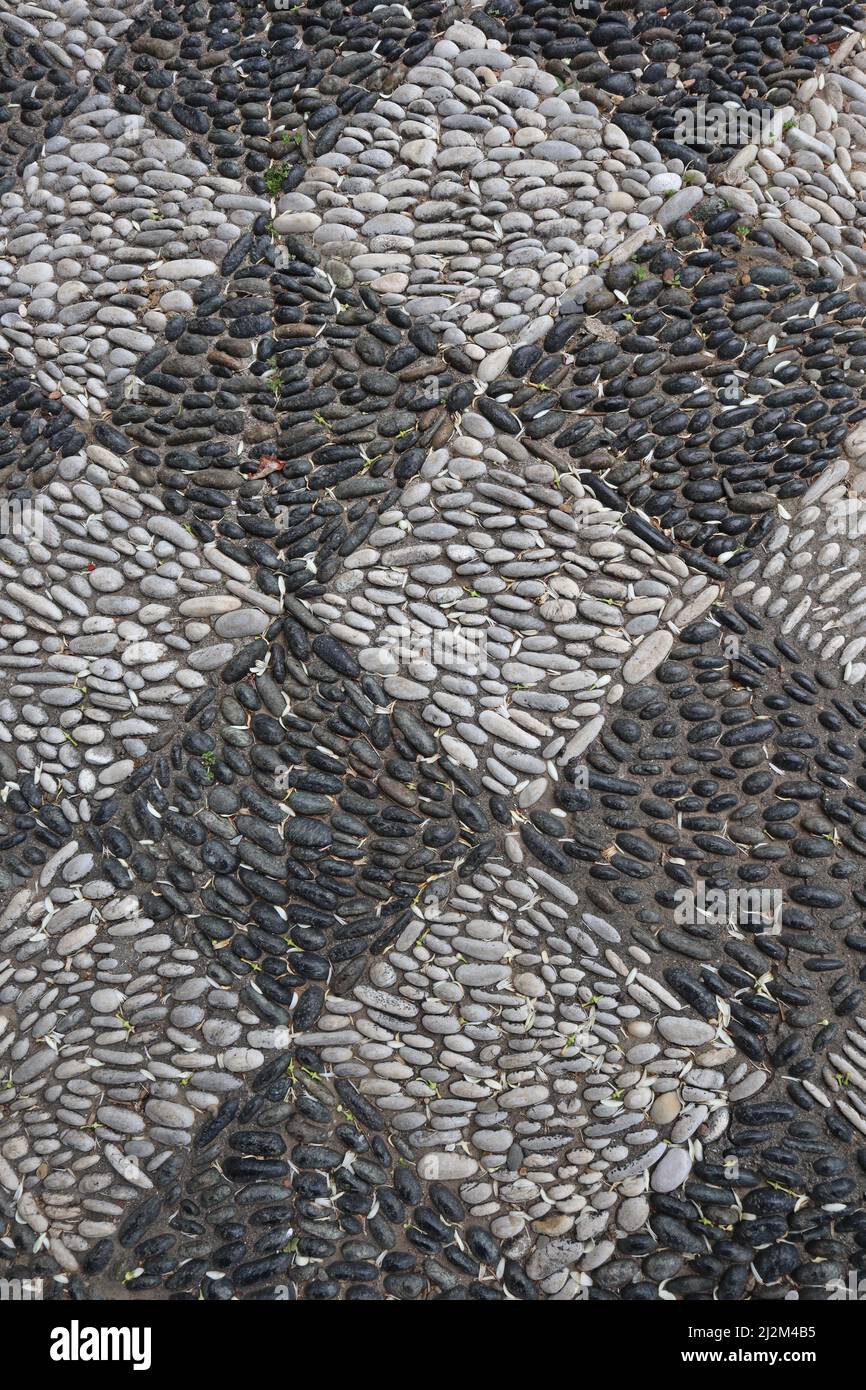 A diamond patterned pavement made from dark and light coloured pebbles ...