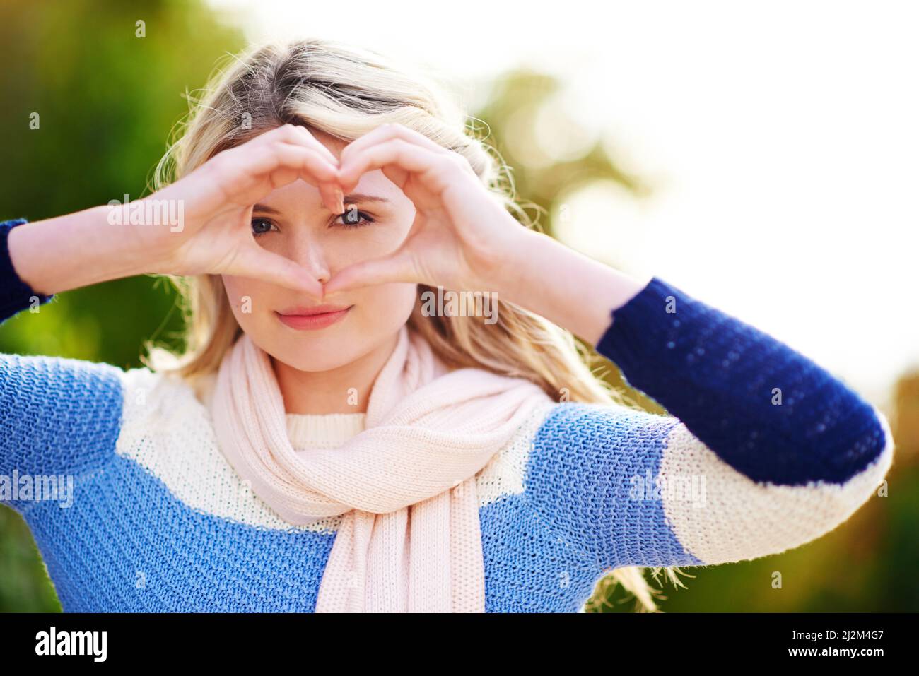 The look of love. Cropped portrait of a young woman looking through her ...