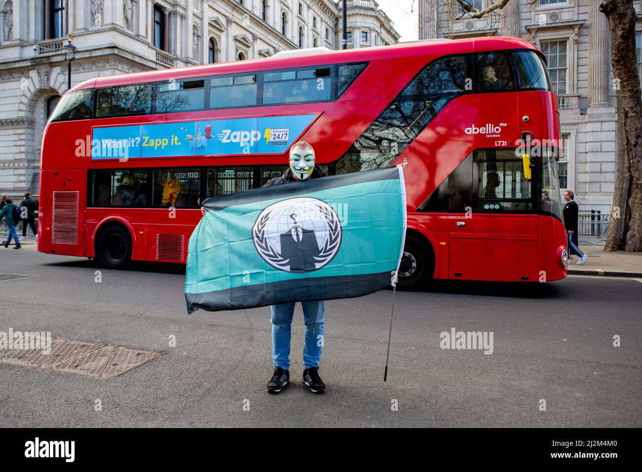 London, UK. 02nd Apr, 2022. A demonstrator waves an 'Anonymous' hacking ...