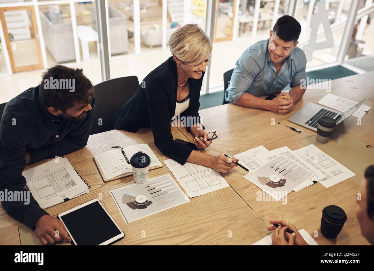 Going over the paperwork. Cropped shot of a group of business ...