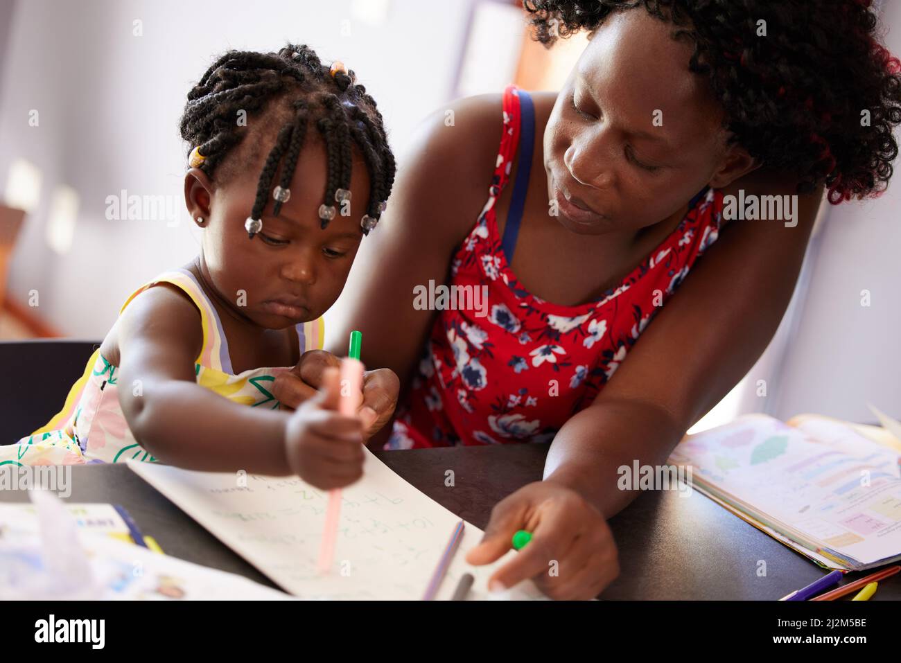 Helping my daughter learn in the best way. Shot of a mother spending ...