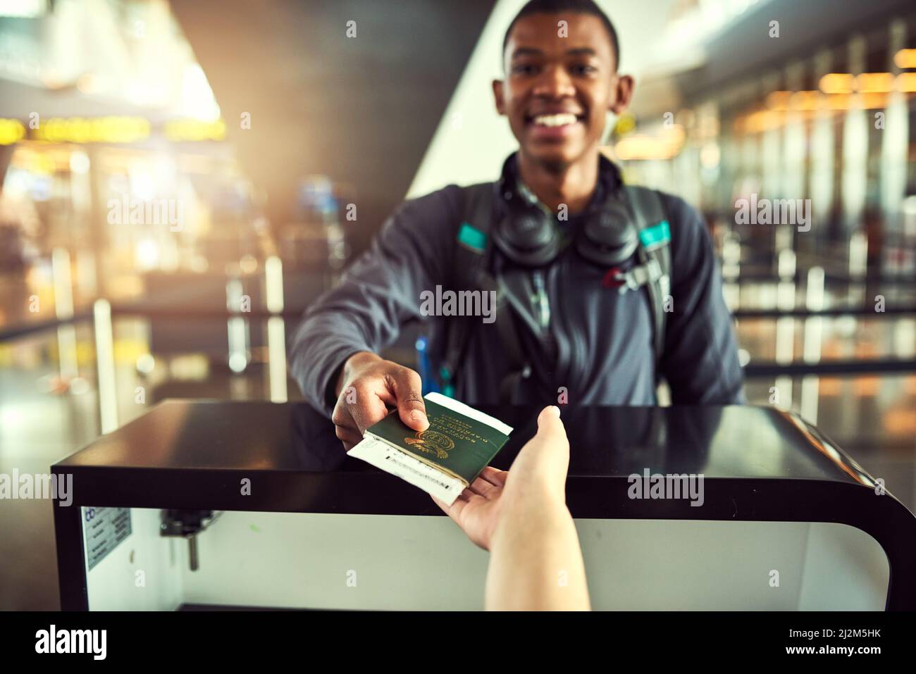 Ready to board. Shot of a young man boarding in an airport Stock Photo ...