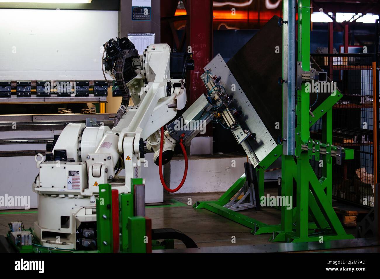 Robotic arm working with metal sheet at hydraulic bending machine Stock ...