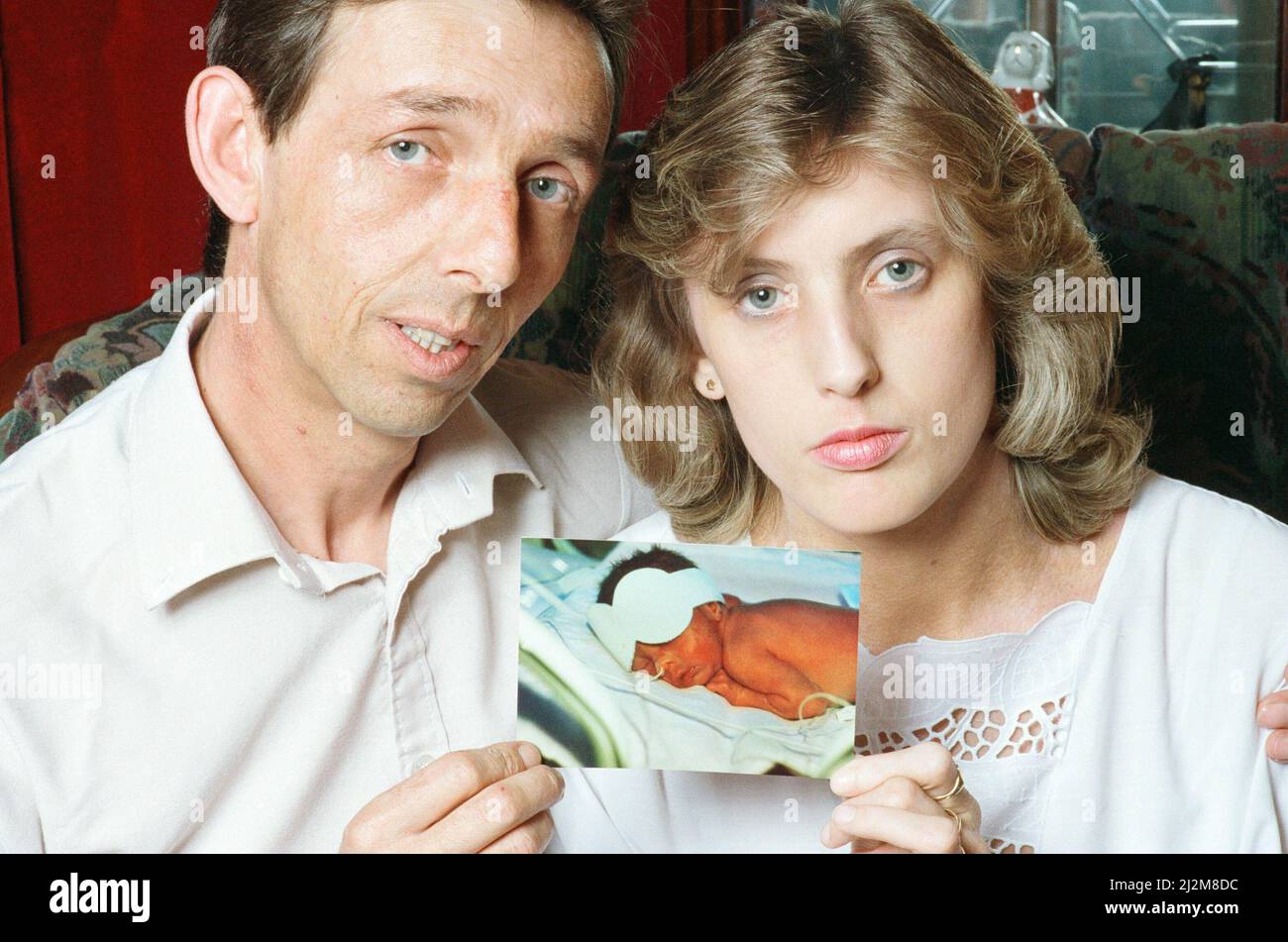 Grieving couple Susan and Peter Phillips with a photograph of their ...
