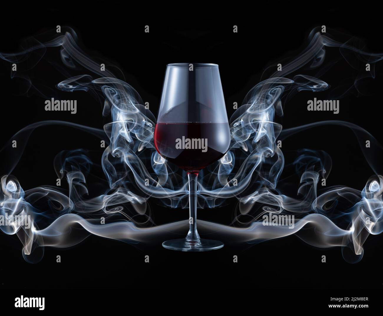 Closeup of a red wine glass in front of a smoke installation Stock ...