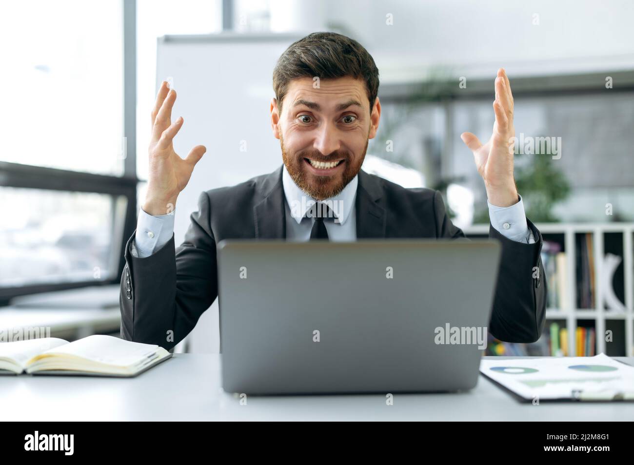 Shocked confused business man with a beard in business suit, manager ...
