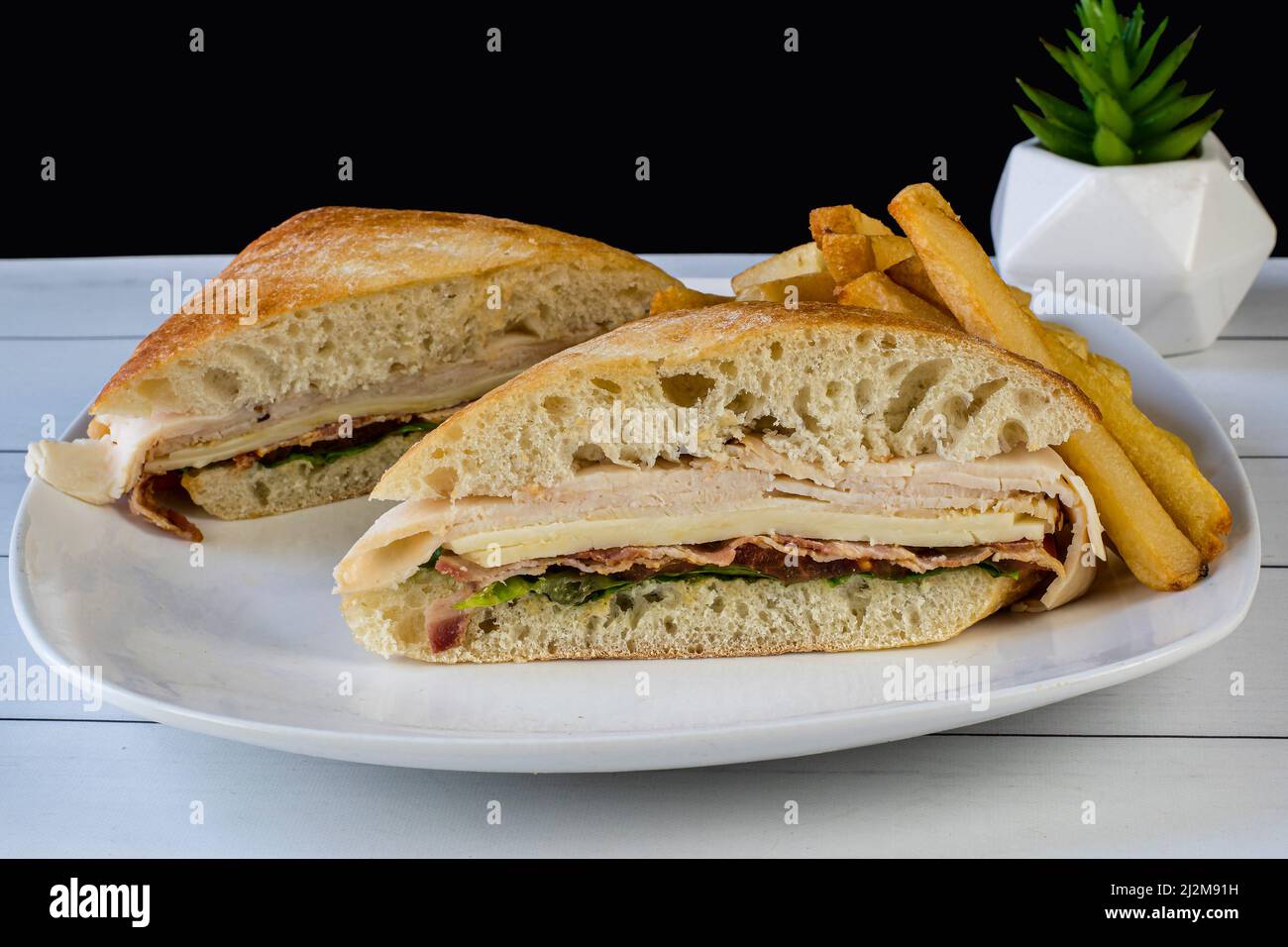 chicken club sandwich served with french fries Stock Photo - Alamy