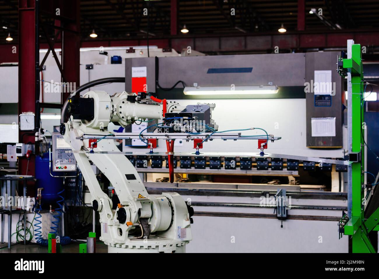 Robotic arm working with metal sheet at hydraulic bending machine Stock ...