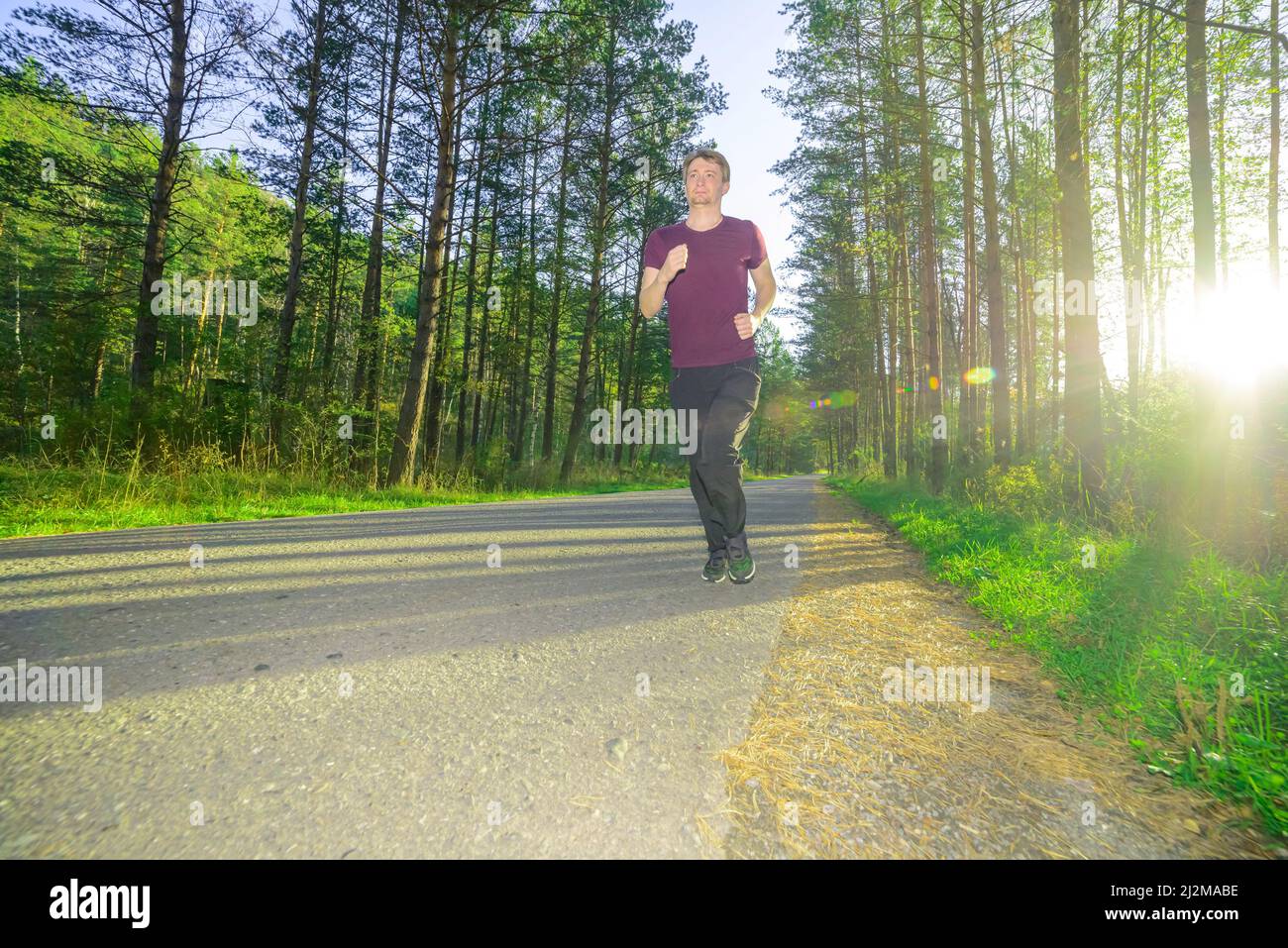 Running man jogging in city park at beautiful summer day. Sport fitness ...