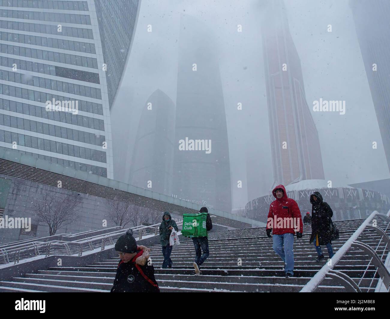 People walk down the stairs during a heavy snowfall. Cyclone Katrina ...