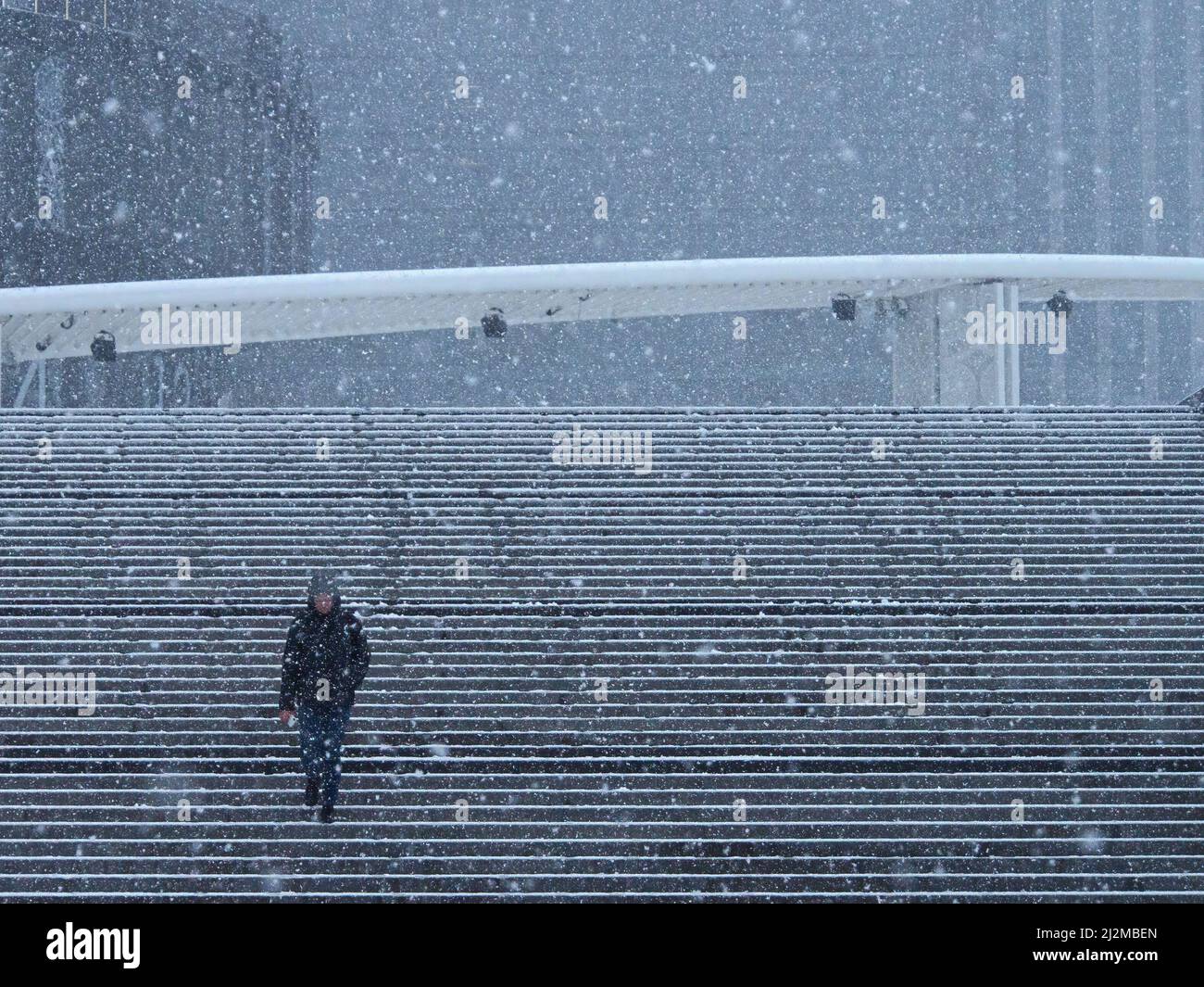 A man walks down the stairs during a heavy snowfall. Cyclone Katrina ...