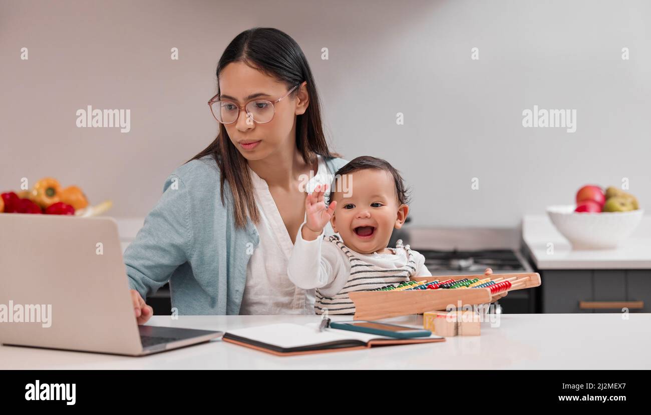 Building a life for the two of us. Shot of a young mother working from ...