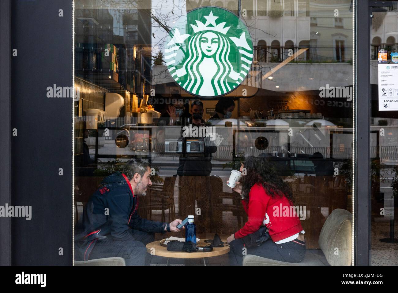 Customers are seen at the American multinational chain Starbucks Coffee ...
