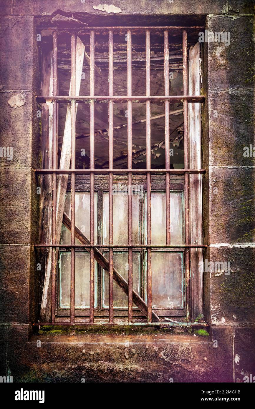 Old glass window behind bars of a prison building Stock Photo - Alamy
